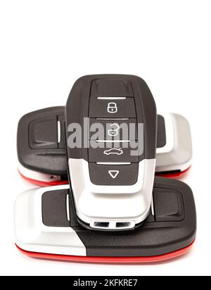 Car keys lie in different poses on a white background. Black and red ...