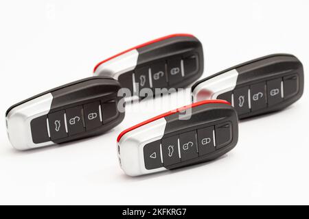 Car keys lie in different poses on a white background. Black and red ...