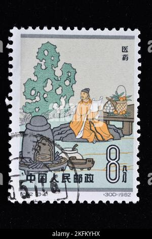 CHINA- CIRCA 1962. A stamp printed in China depicting traditional wear ...