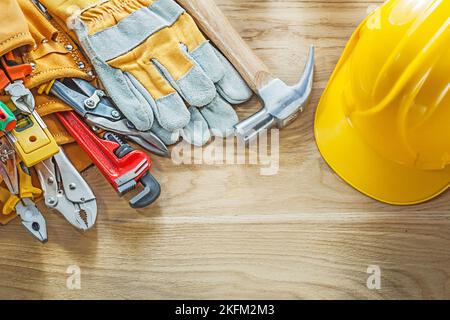 Building helmet protective gloves monkey wrench on wooden board ...