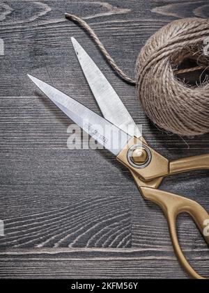 Vintage metal golden scissors hank of rope on wooden board Stock Photo ...
