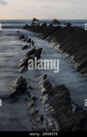 Stunning sunset landscape image of Welcome Mouth Beach in Devon England ...