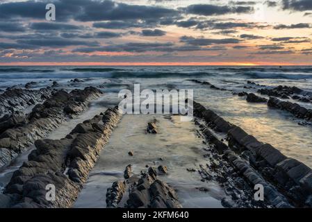 Stunning sunset landscape image of Welcome Mouth Beach in Devon England ...