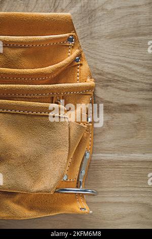 Leather construction belt on wooden board Stock Photo - Alamy