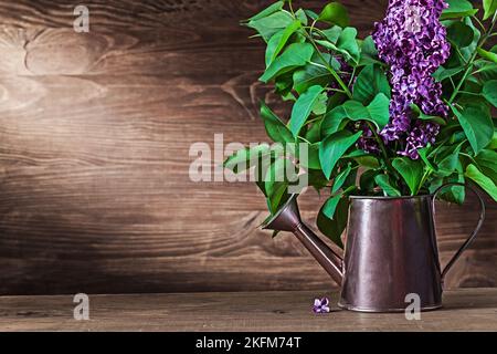lilac flowers in vintage watering can on wood Stock Photo - Alamy