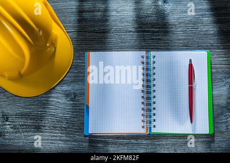 Spiral notepad pen building helmet on wooden board Stock Photo - Alamy