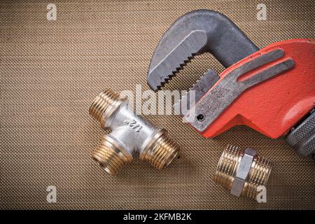 Plumbers wrench brass plumbing fixtures on mesh filter grid Stock Photo ...
