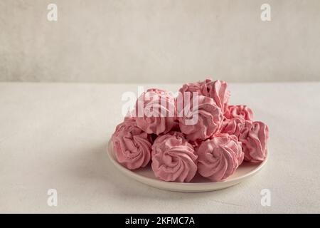Delicious sweet zephyr and cherries on a light background, the concept ...