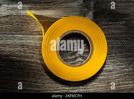 Rolled electrical tape on vintage wooden board Stock Photo - Alamy