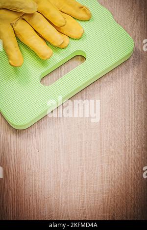 Leather gloves garden foam kneeling mat hand spade secateurs on wood ...