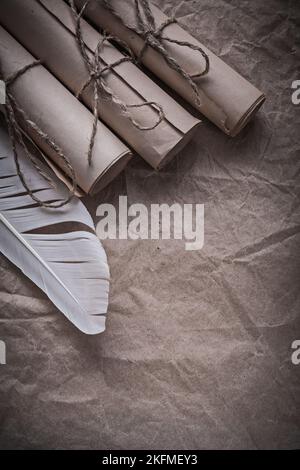 Stack of vintage paper scrolls quill on crumpled wrapping sheet Stock ...