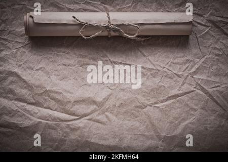 Vintage paper roll on crumpled wrapping sheet Stock Photo - Alamy