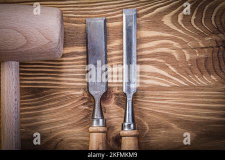 Wooden hammer flat chisels on vintage wood board top view construction ...
