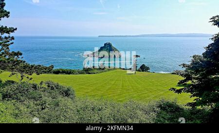 A landscape scene of Thatcher Rock in Torquay, Uk in the sea with gray ...