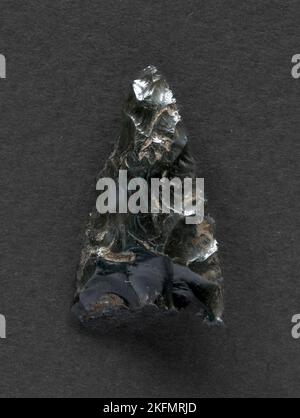 Neolithic obsidian arrowhead on dark background Stock Photo - Alamy