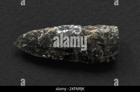 Neolithic obsidian arrowhead on dark background Stock Photo - Alamy