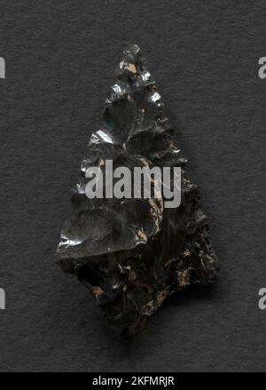 Neolithic obsidian arrowhead on dark background Stock Photo - Alamy