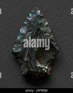 Neolithic obsidian arrowhead on dark background Stock Photo - Alamy