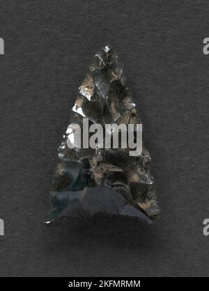 Neolithic obsidian arrowhead on dark background Stock Photo - Alamy