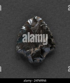 Neolithic obsidian arrowhead on dark background Stock Photo - Alamy