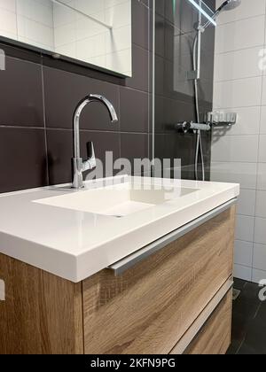 Stylish ceramic tub and modern tab in bathroom Stock Photo - Alamy
