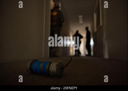 Law enforcement officers walk through a building rigged with model ...