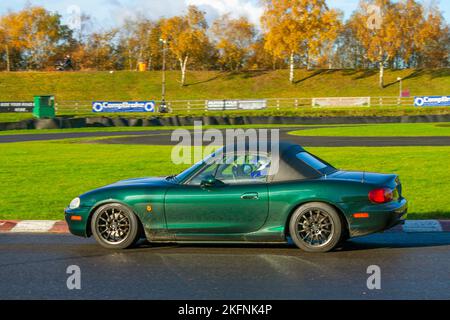 1999, 90s, nineties green Mazda Mx-5driving on challenging high-speed ...