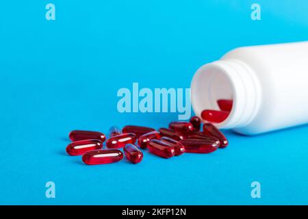 Red pills spilled around a pill bottle. Medicines and prescription ...