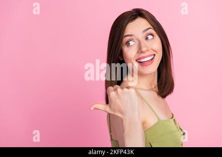 Photo of adorable excited woman dressed plaid shirt pointing up empty ...