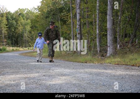 Col. Mullins was accompanied by his 8-year-old grandson, Blake, during ...