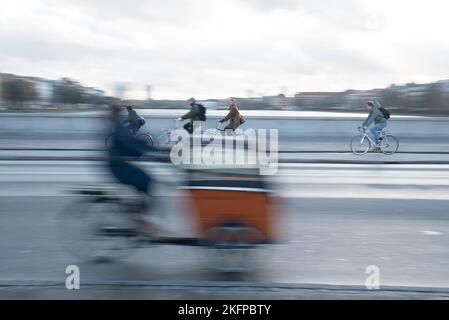 Cyclists on bikes pedal around Copenhagen, Denmark, one of the Greenest ...