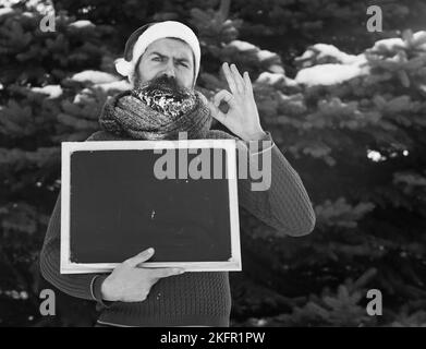Frown man in santa claus hat, hipster with beard and moustache covered ...