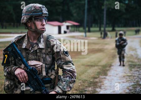 Army Reserve Spc. Brady A. Benedict (center), a military policeman ...