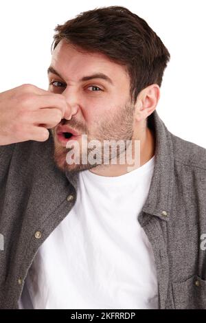 Displeased person holding her nose isolated. Disgust young girl ...