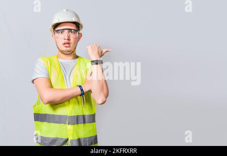 Surprised engineer pointing to the side. Surprised face construction ...
