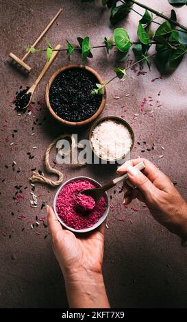 Crop anonymous female demonstrating pink quartz roller for facial skin ...