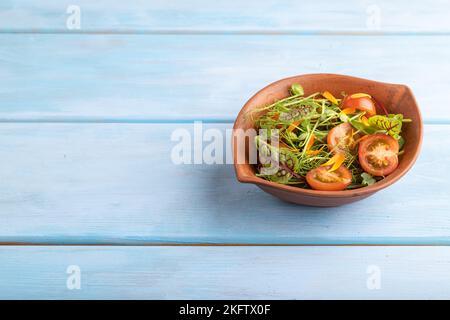 Vegetarian vegetables salad of tomatoes, marigold petals, microgreen ...