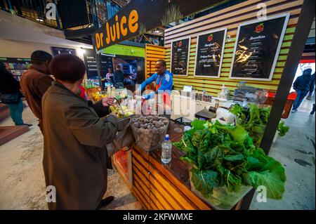 Tourists enjoying snacks at the V & A Foodmarket, V & A Waterfront ...