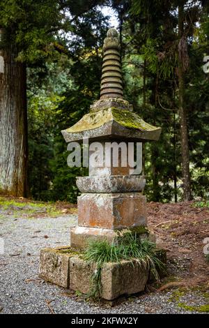 A close up of a traditional toro stone lantern within a Japanese garden ...