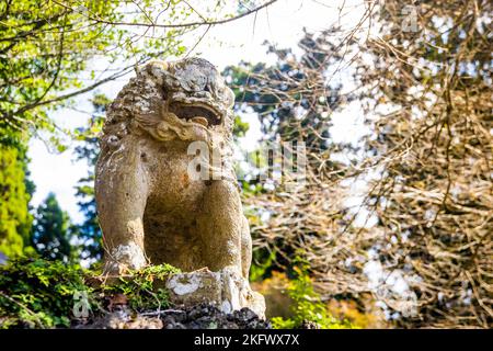 Japanese ancient statue of demon in stone in forest park at day Stock ...