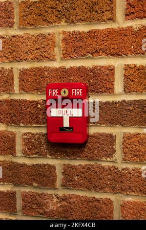 Manual fire alarm activation pull station on wall - signage reading ...