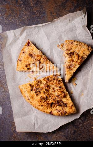 Grated cake with jam and nut filling on parchment Stock Photo - Alamy