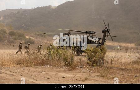 Soldiers from Charlie Troop, 3rd Brigade Combat Team, 82nd Airborne Division load into a ...
