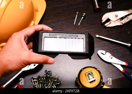 Auto darkening welding glasses in the mechanic hand with a welding on ...