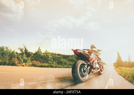 Motorcycle parked alone on a sunny road in the evening,Motorbike ...