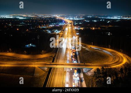 Convoy transporting heavy equipment, aerial night landscape of TBM ...