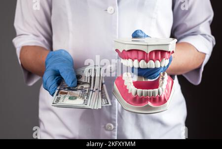 Expensive dentistry concept. Dentist with dollars money for teeth ...