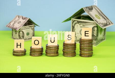 A row of American quarters with wooden block letters and money houses ...