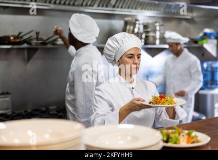 Portrait of woman chef giving out meal Stock Photo - Alamy