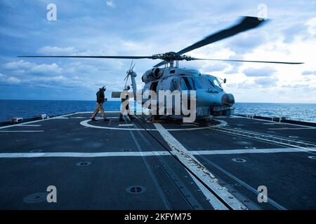 Capt. Simon McKeon, commanding officer, USS Normany, right, and Ens ...